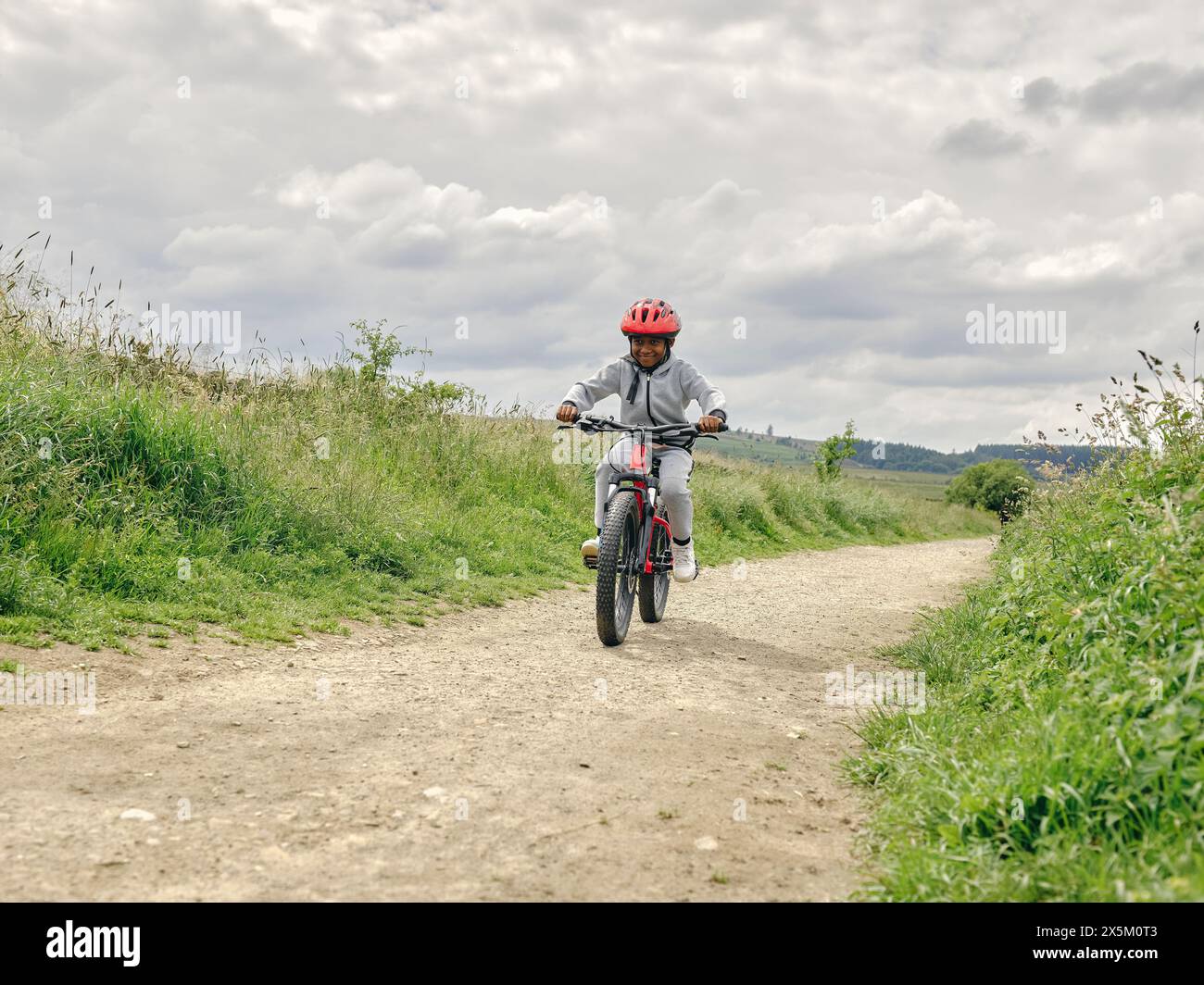 Boy riding bicycle in countryside Stock Photo - Alamy