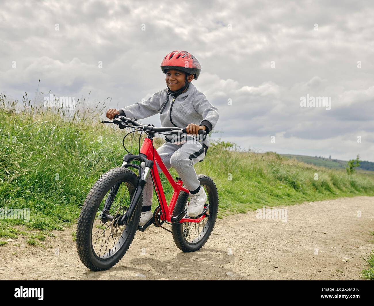 Boy riding bicycle in countryside Stock Photo - Alamy
