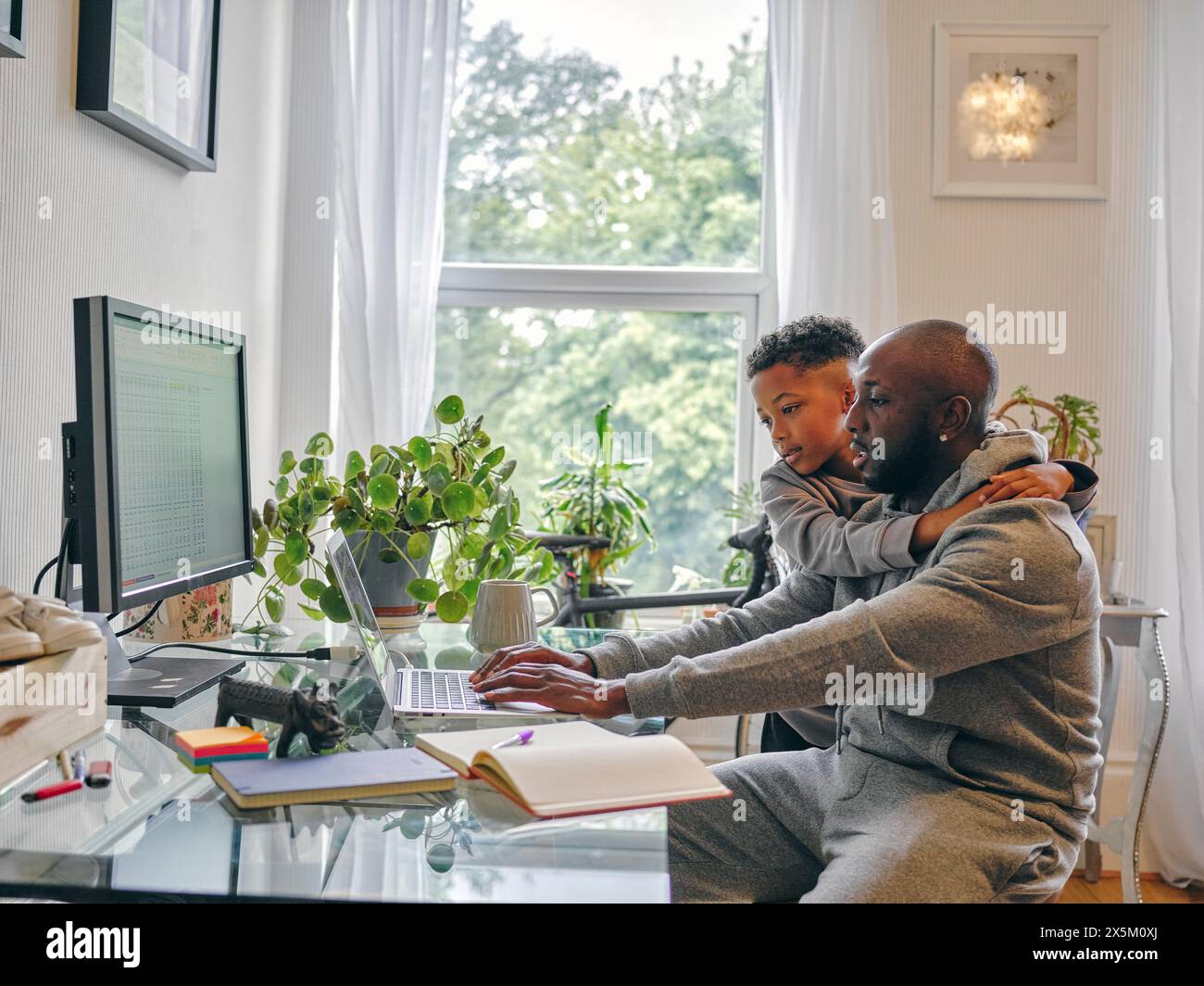 Father and son using computer at home Stock Photo - Alamy