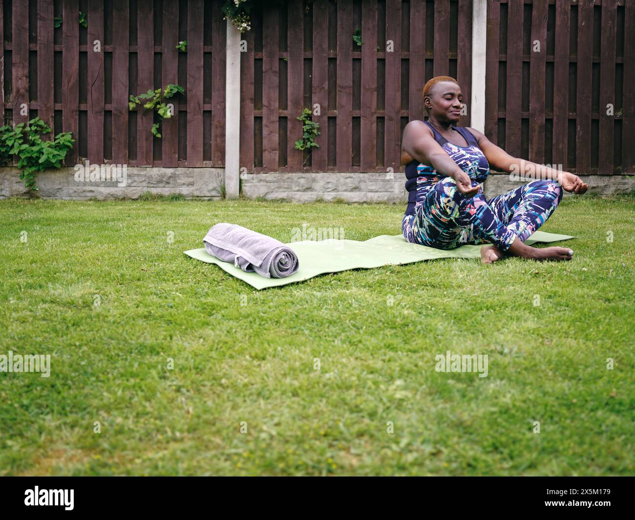 Woman meditating on mat in hi-res stock photography and images - Alamy