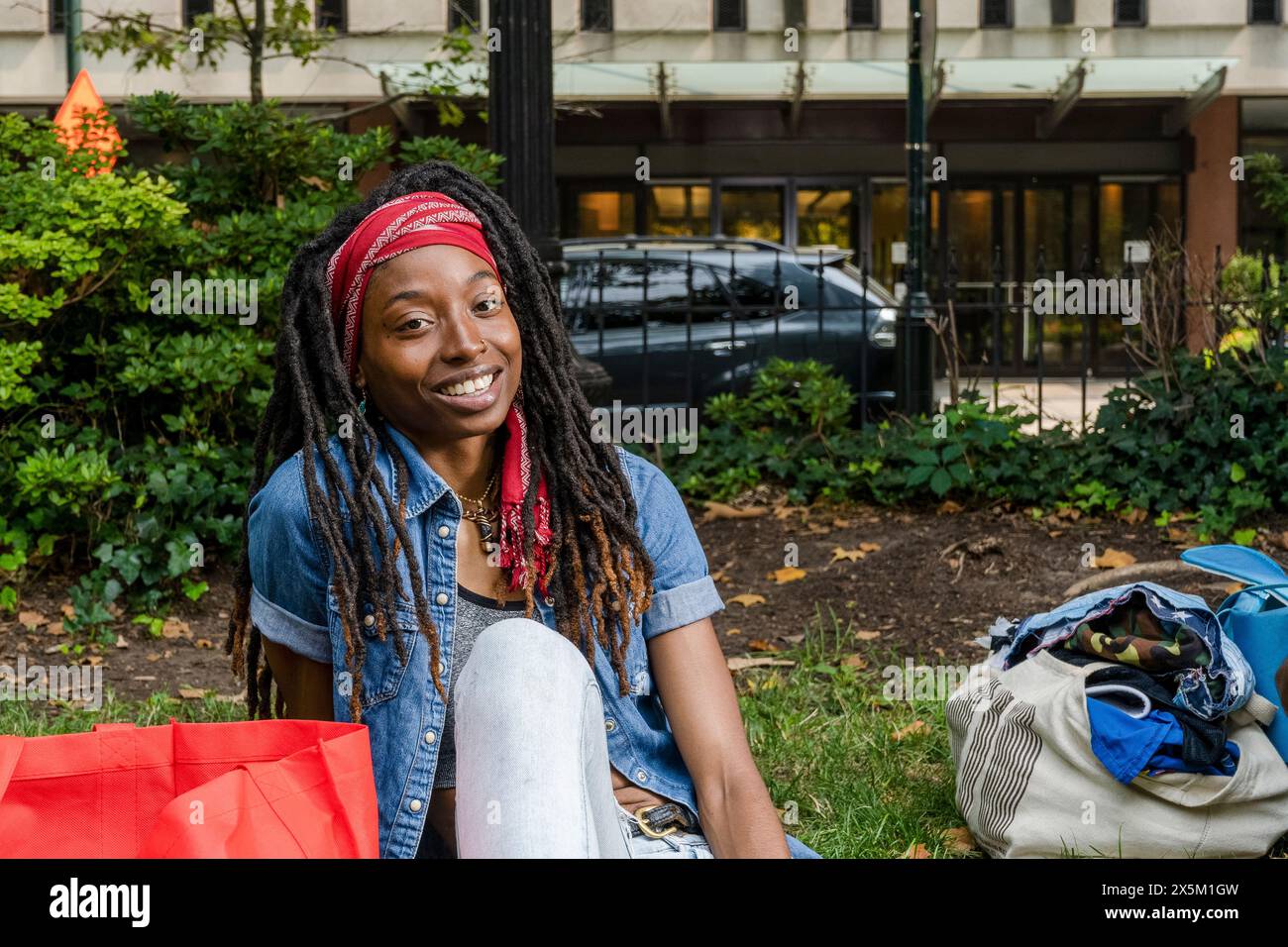 Smiling woman dreadlocks sitting hi-res stock photography and images ...