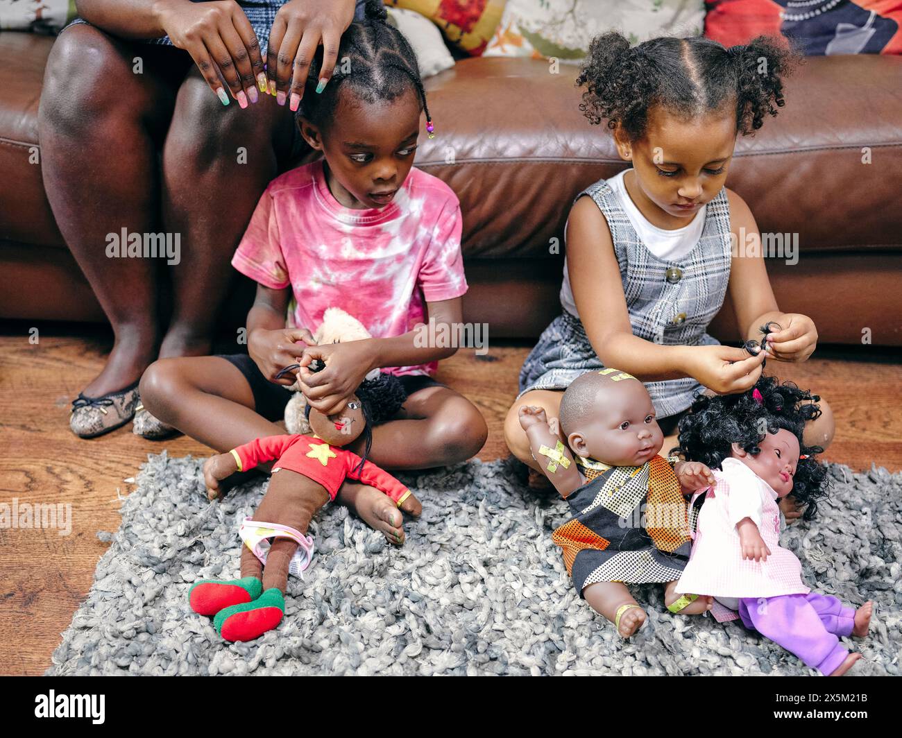 Girls playing with dolls hi-res stock photography and images - Alamy