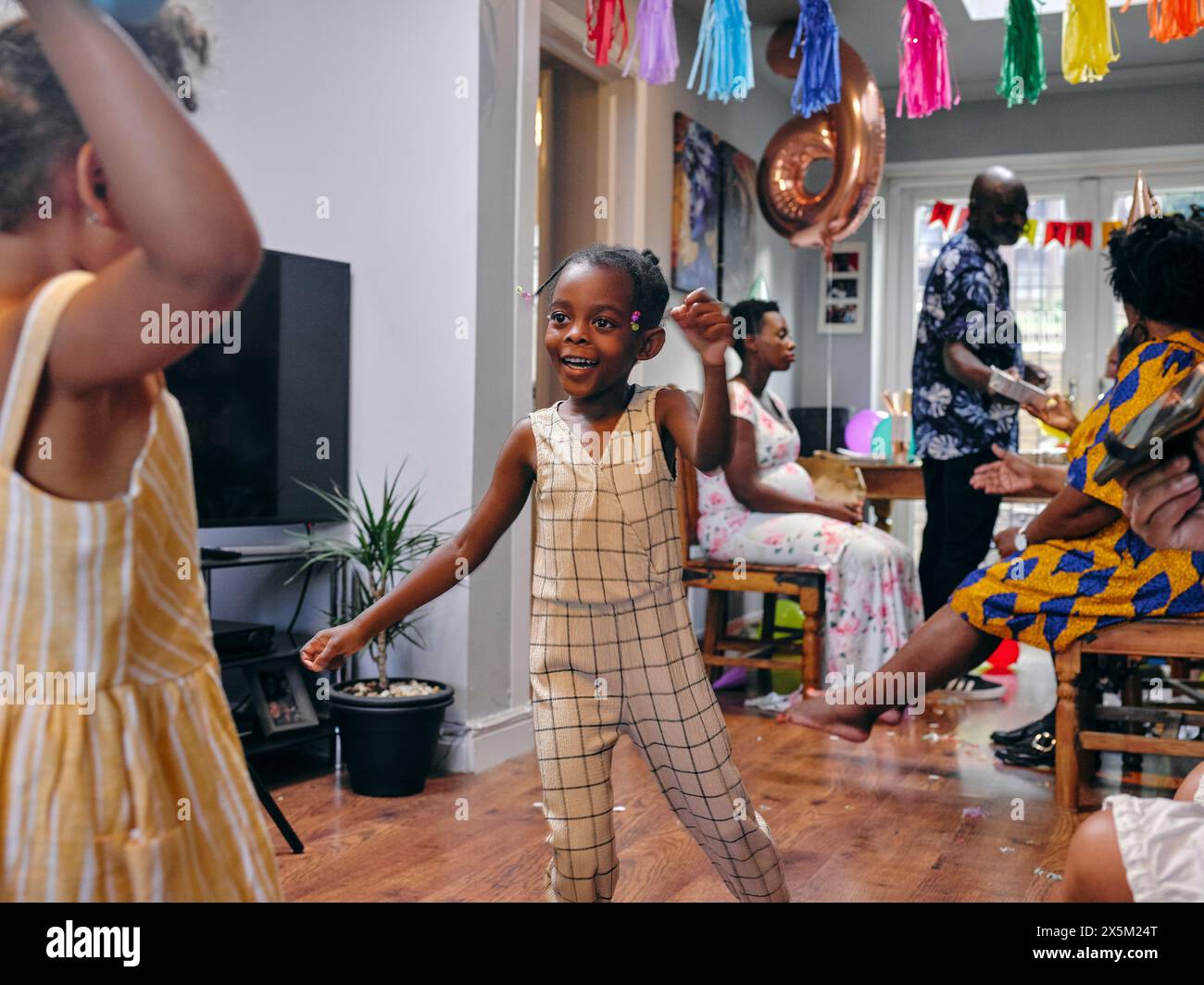 Girls dancing at family birthday party Stock Photo - Alamy