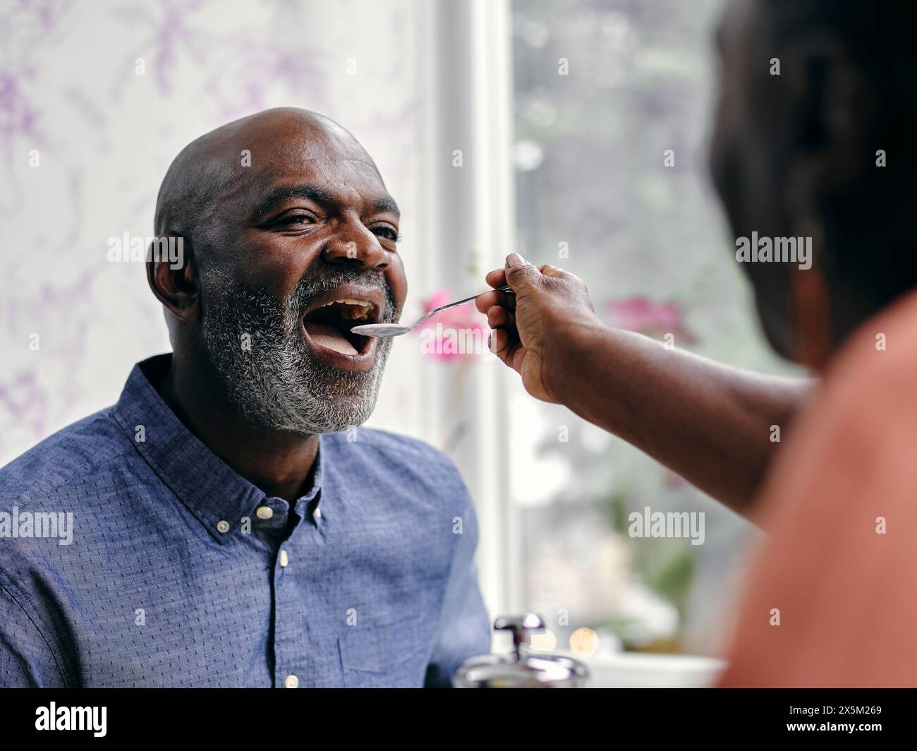 UK, Close-up of woman feeding man at hotel table Stock Photo - Alamy