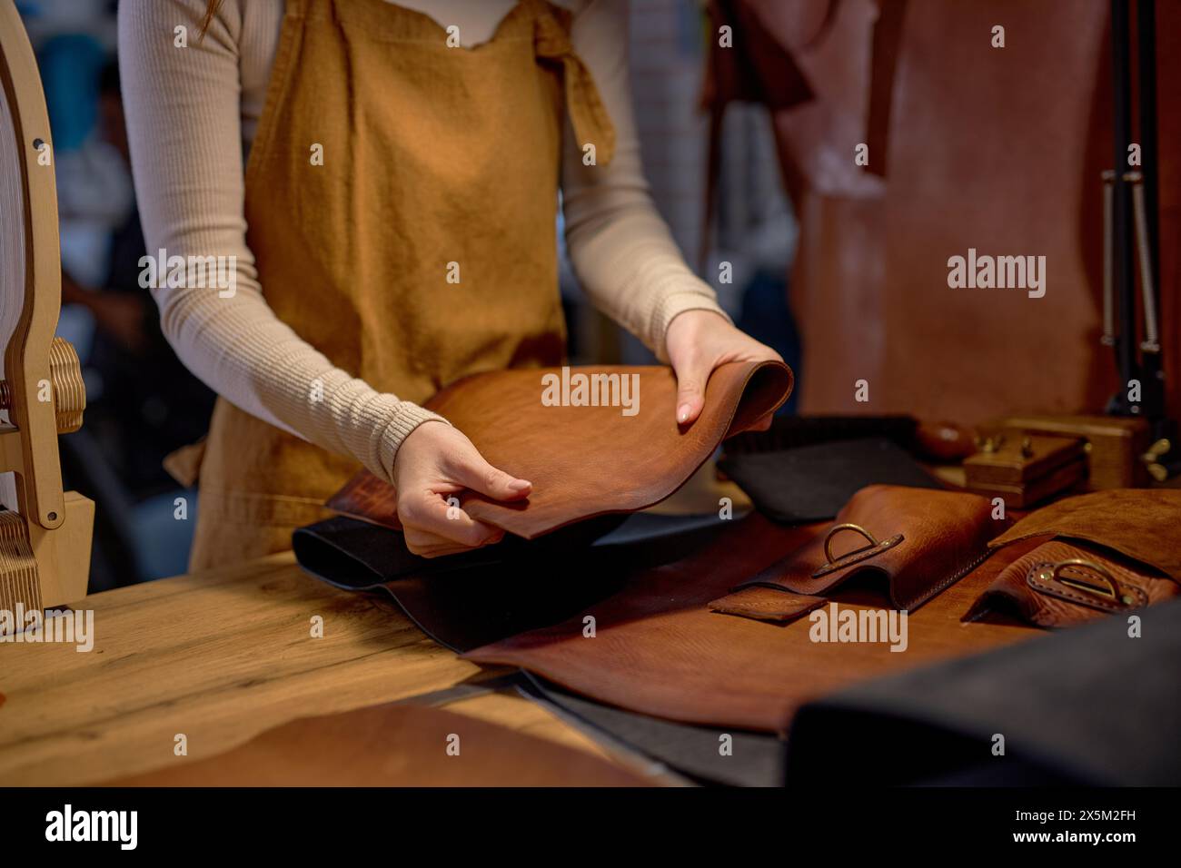 hands touching, holding cut leather, close up cropped side view shot ...