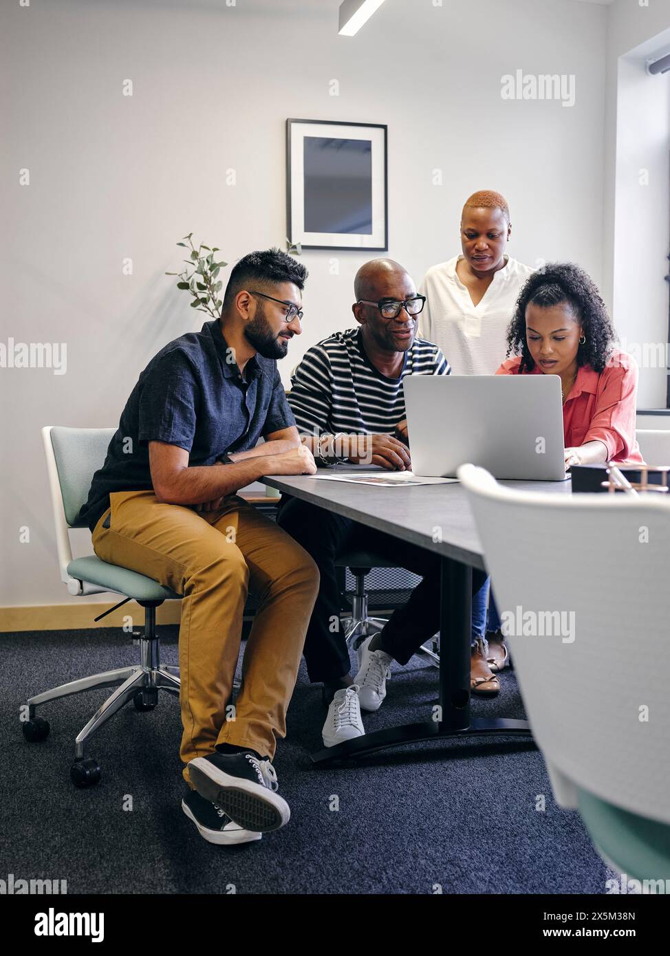 Business colleagues looking laptop hi-res stock photography and images ...