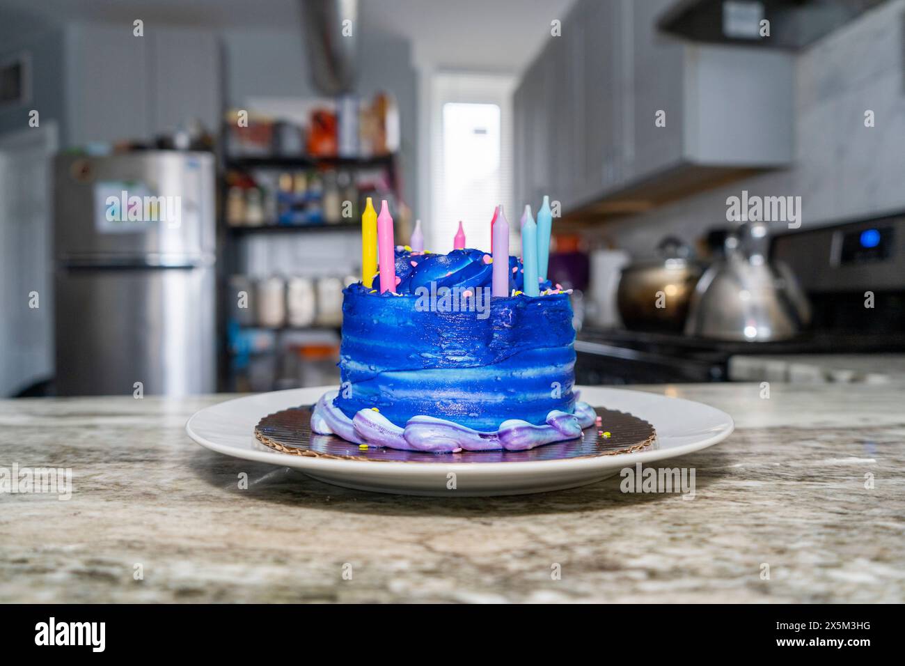 Blue birthday cake on kitchen counter Stock Photo - Alamy