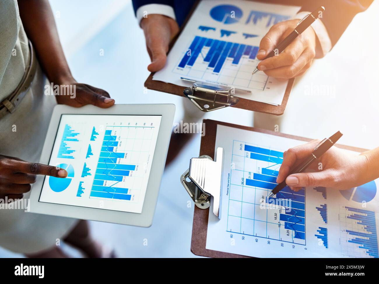 Tablet, clipboard and hands of business people with charts, graphs and metrics in productivity ...