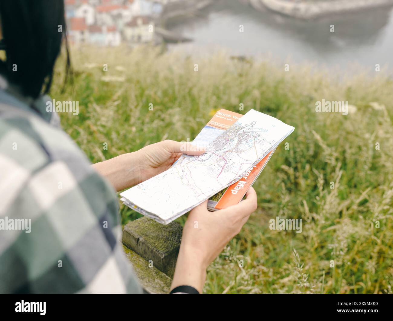 UK, Close-up of female hiker looking at map in landscape Stock Photo ...
