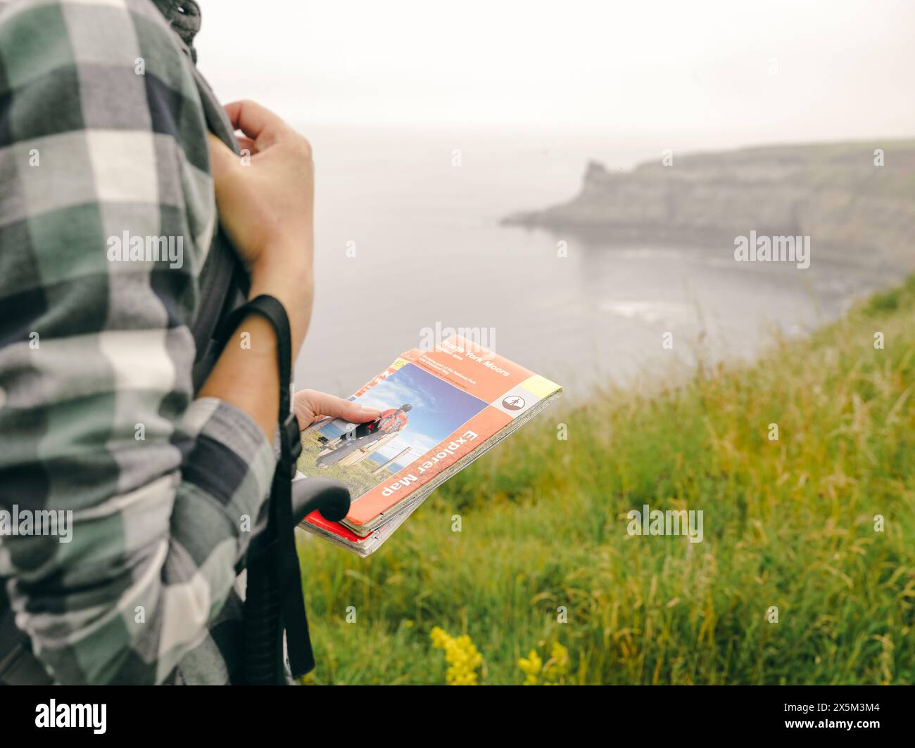 UK, Close-up of female hiker holding map at sea coast Stock Photo - Alamy