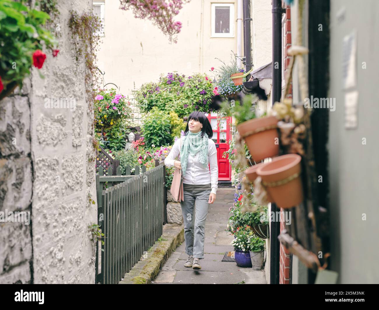 UK, Woman walking n narrow alley in old town Stock Photo - Alamy
