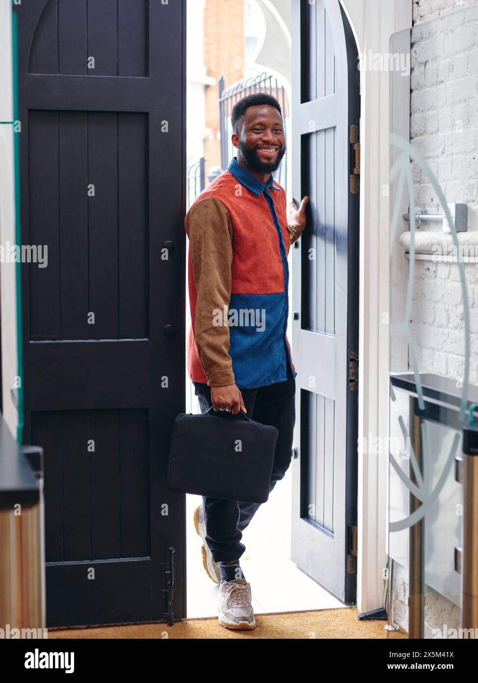 Person entering building hi-res stock photography and images - Alamy