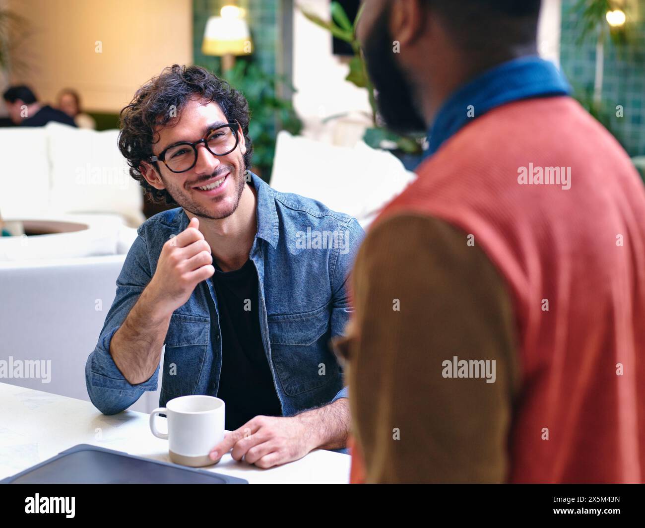 Down men smiling two hi-res stock photography and images - Alamy