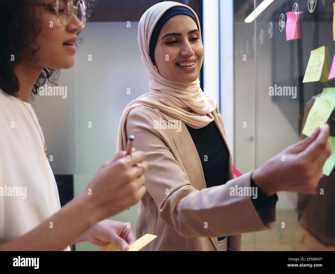 UK, London, Women using adhesive notes in office Stock Photo - Alamy