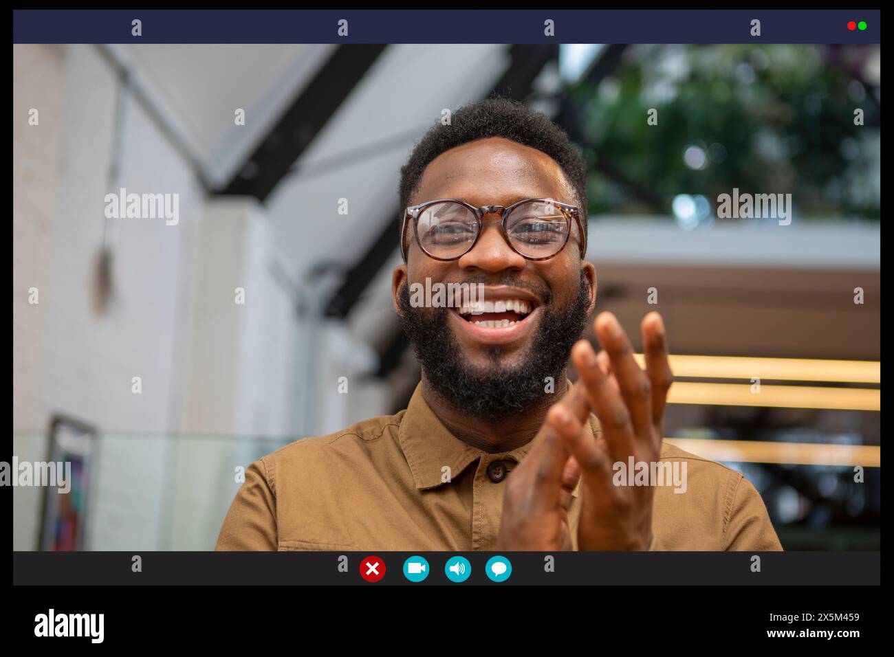 Smiling man clapping in video call Stock Photo - Alamy