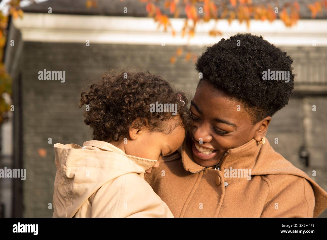 Smiling mother holding daughter Stock Photo - Alamy Smiling mother holding daughter Stock Photo - Alamy
