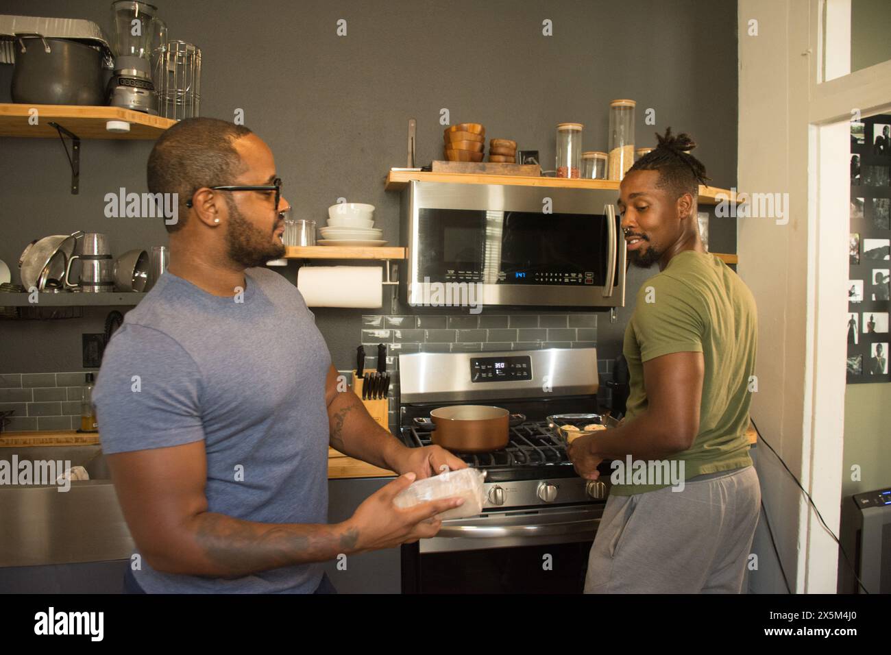 Two gay men cooking hi-res stock photography and images - Alamy