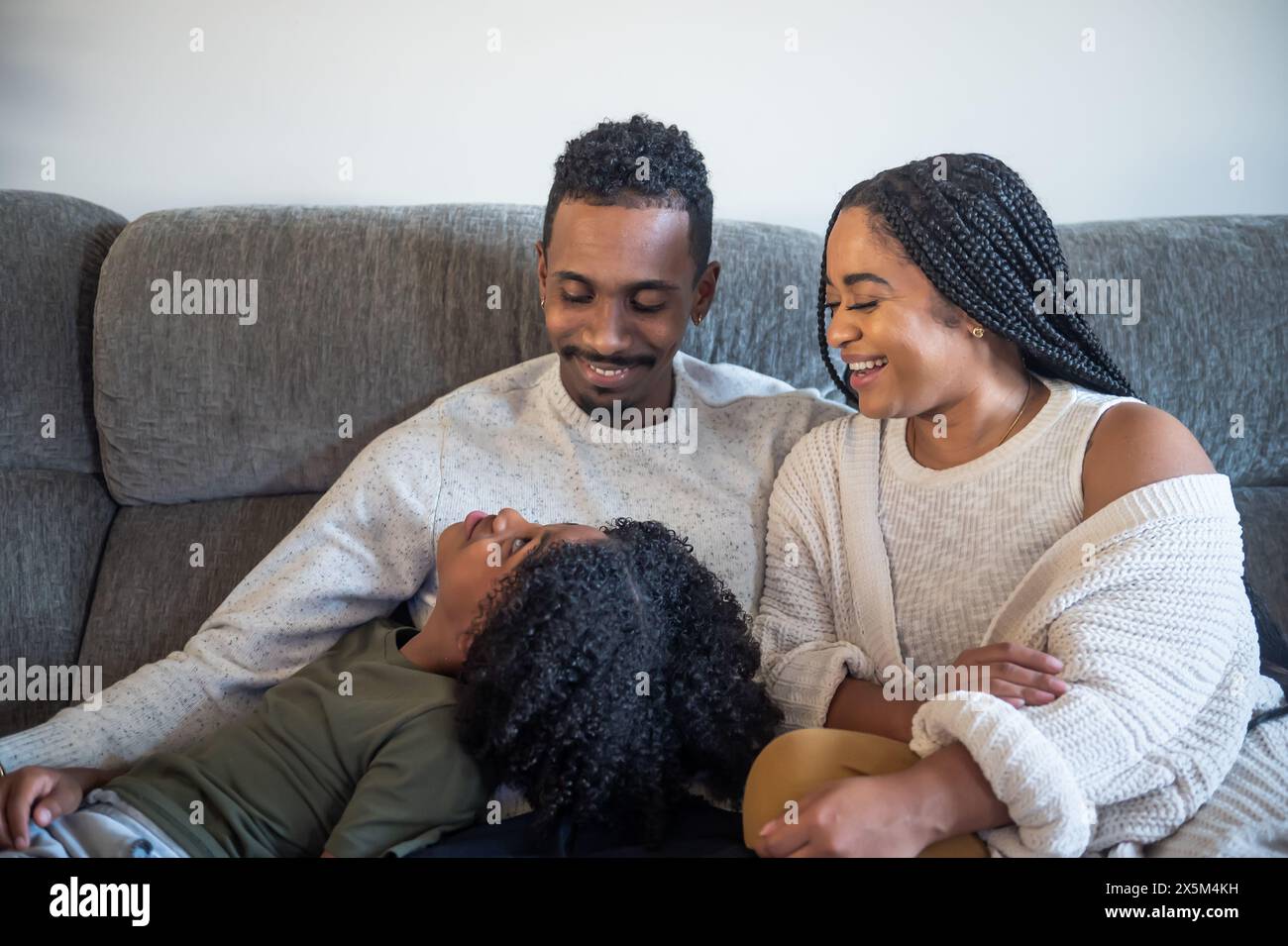 Smiling parents sitting on hi-res stock photography and images - Alamy