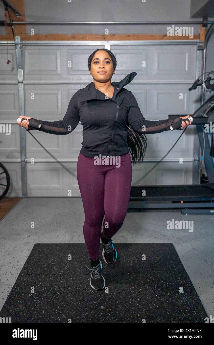 Woman jumping rope in gym Stock Photo - Alamy