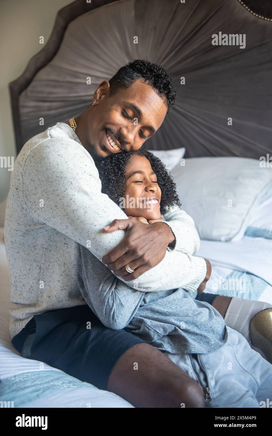 Man with prosthetic leg hugging son in bedroom Stock Photo - Alamy