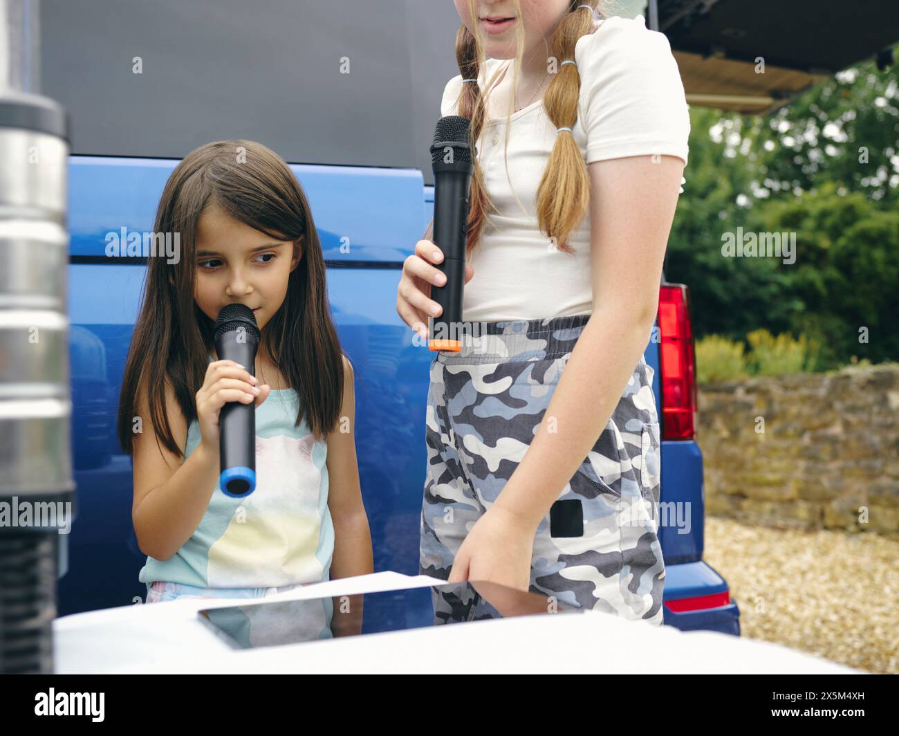 Girls singing karaoke Stock Photo - Alamy