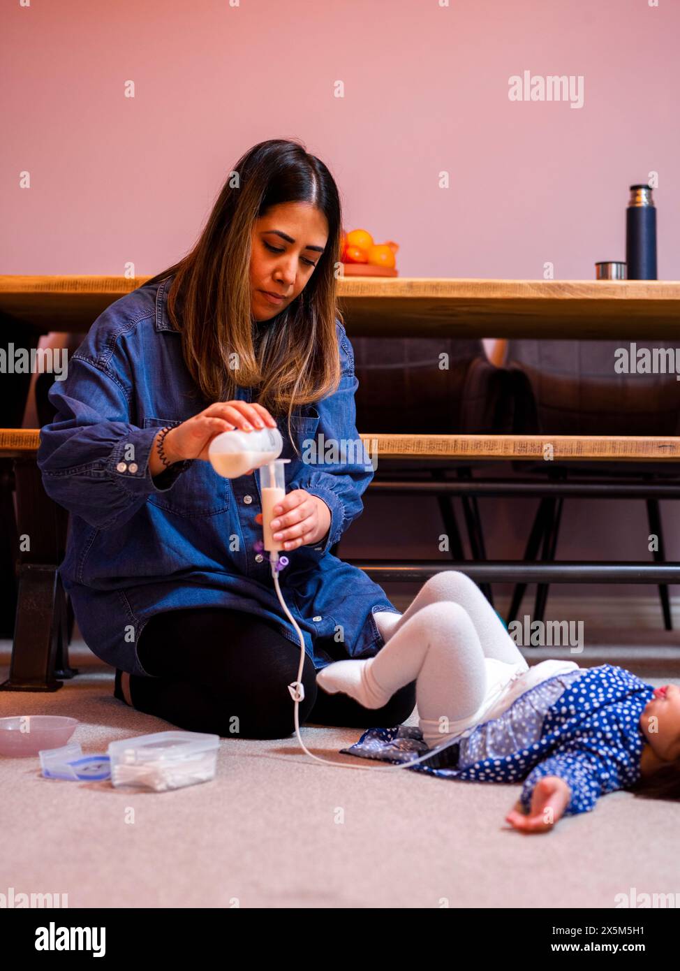 Mother feeding daughter through feeding tube Stock Photo - Alamy
