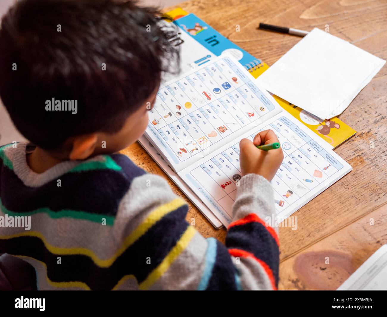 Boy doing homework Stock Photo - Alamy