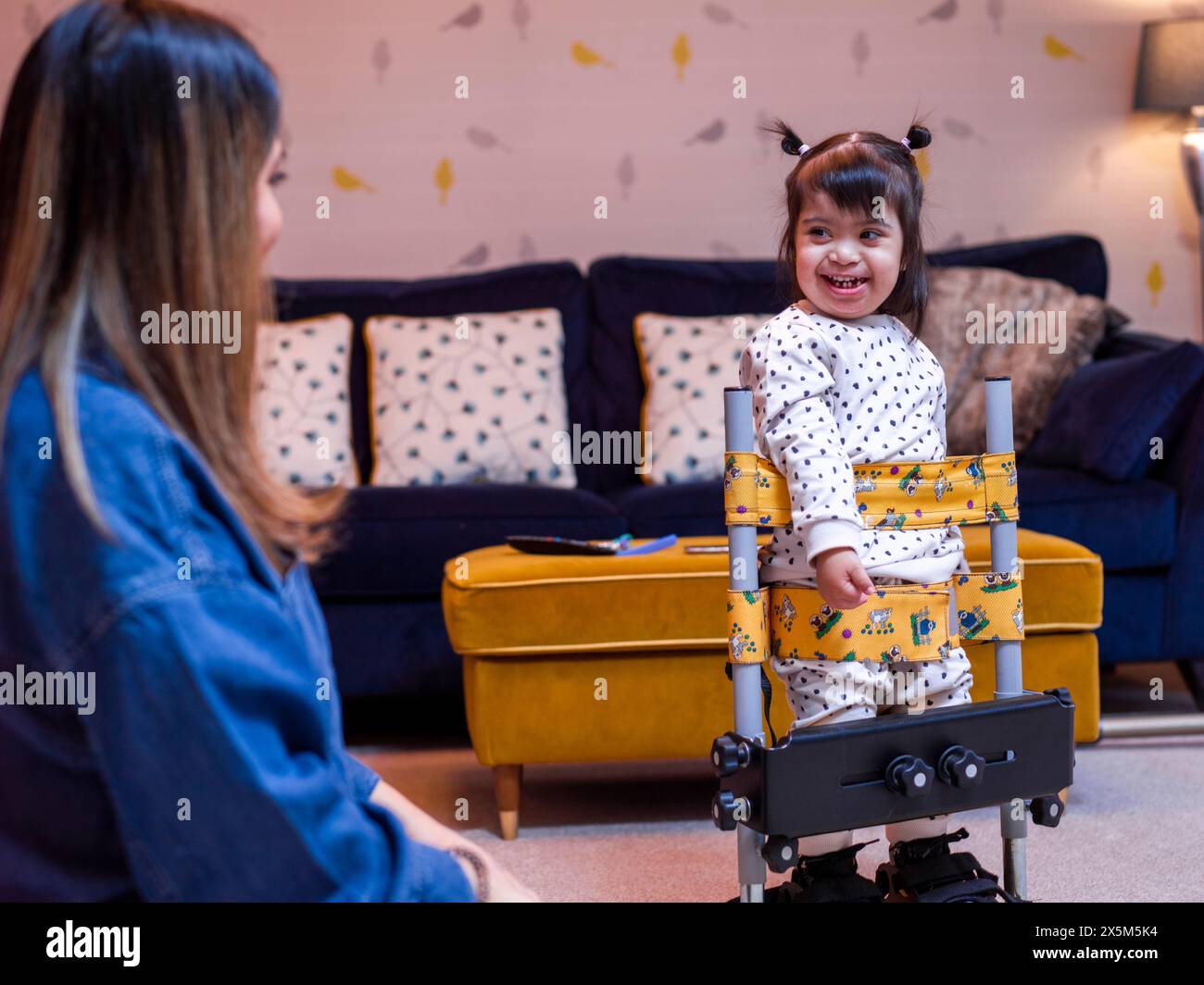 Girl in standing frame smiling to mother Stock Photo - Alamy