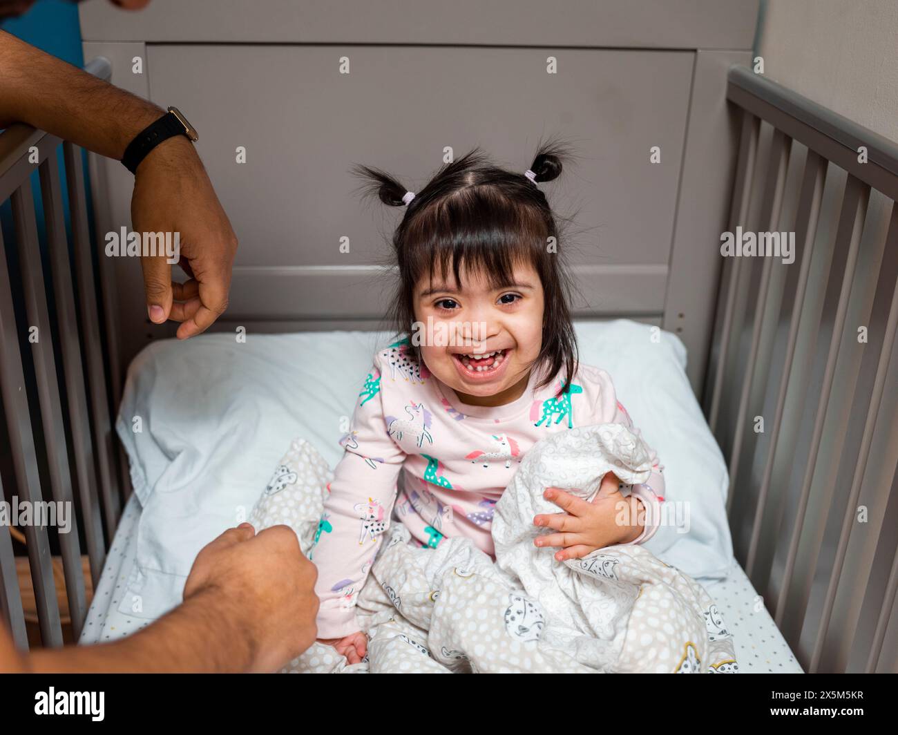 Father putting daughter to sleep Stock Photo - Alamy