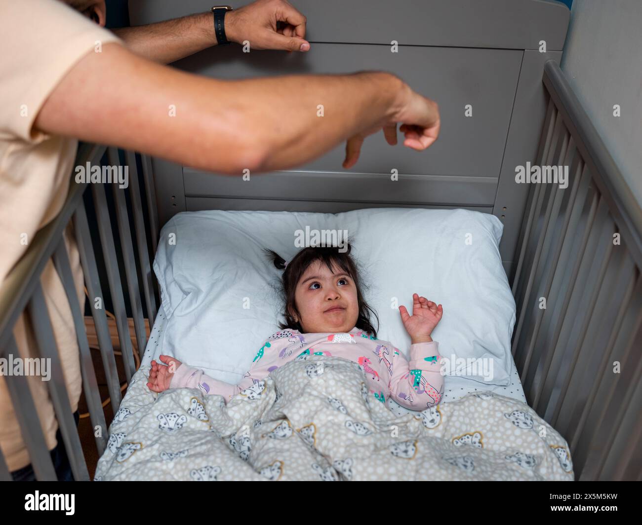 Father putting daughter to sleep Stock Photo - Alamy