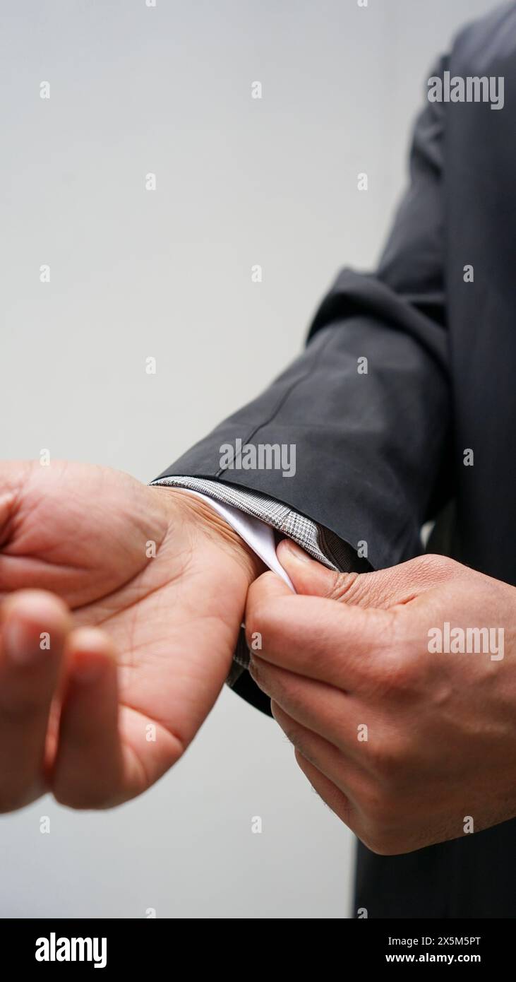 Business man adjusting sleeves, close up Stock Photo - Alamy