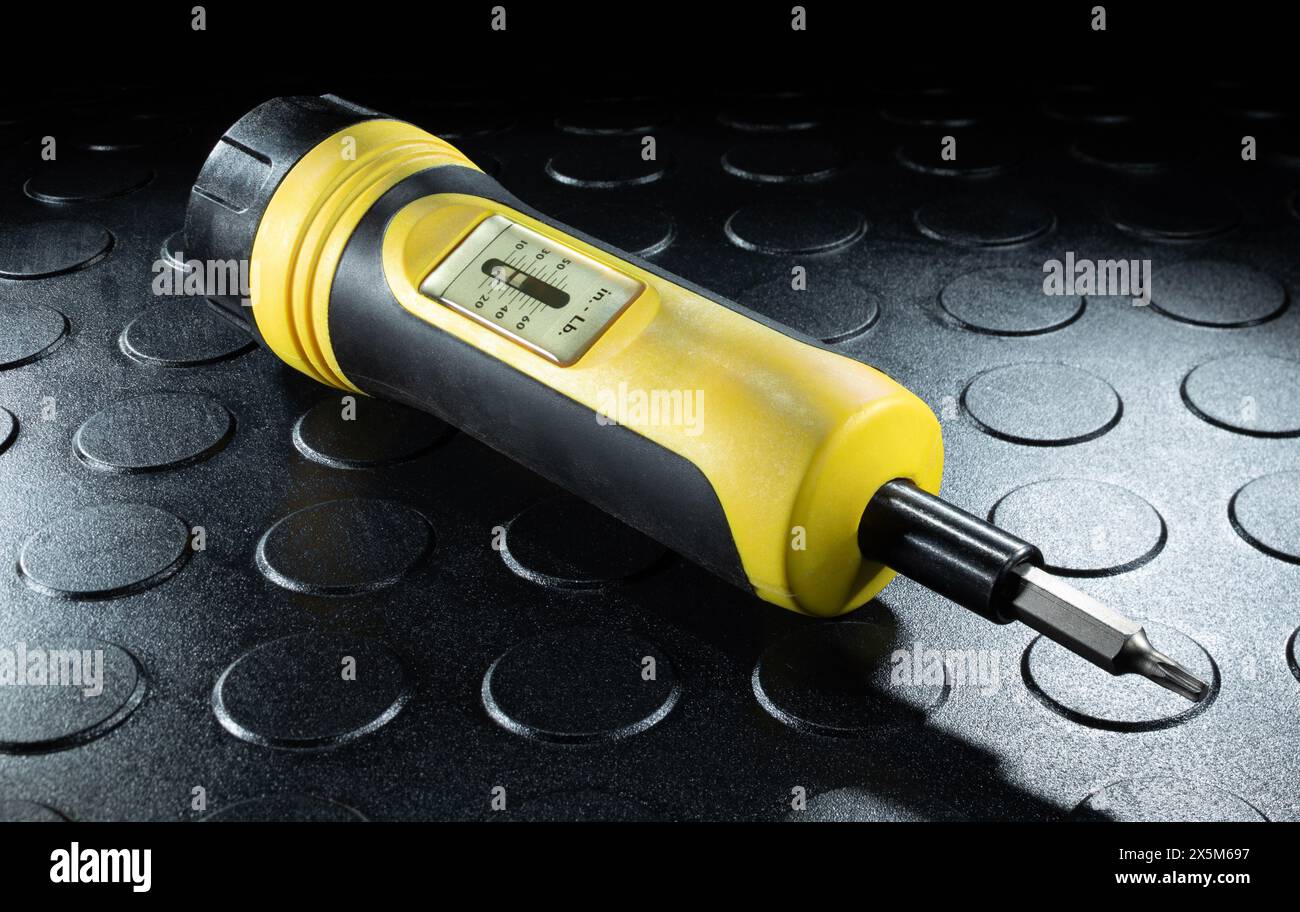 Torque driver that tightens in inch pound increments with a yellow and ...