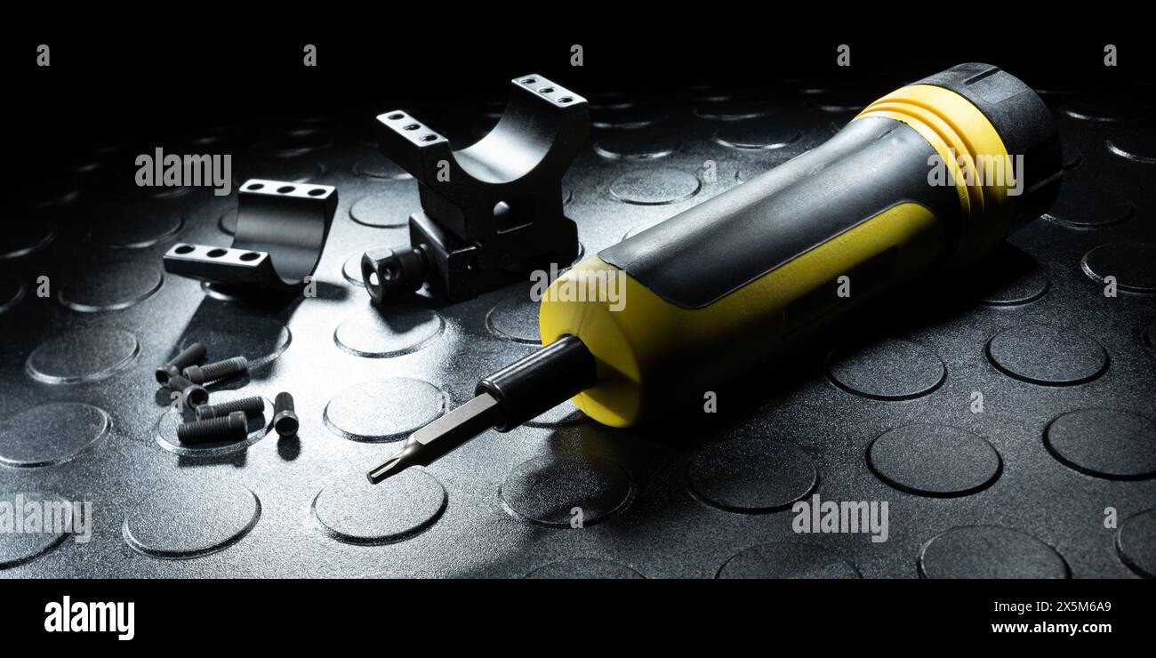 Base, ring and bolts to affix a scope to a rifle with the torque driver ...