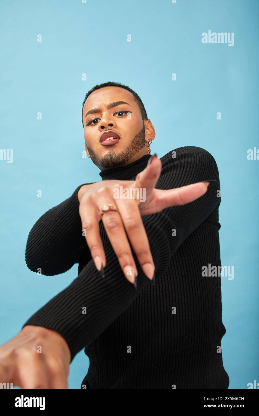 Studio portrait of smiling queer man Stock Photo - Alamy