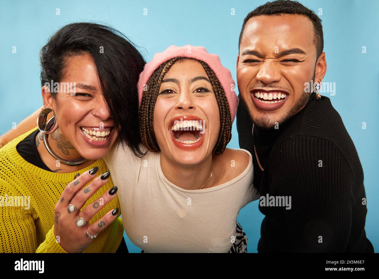 Studio portrait of stylish friends laughing Stock Photo - Alamy