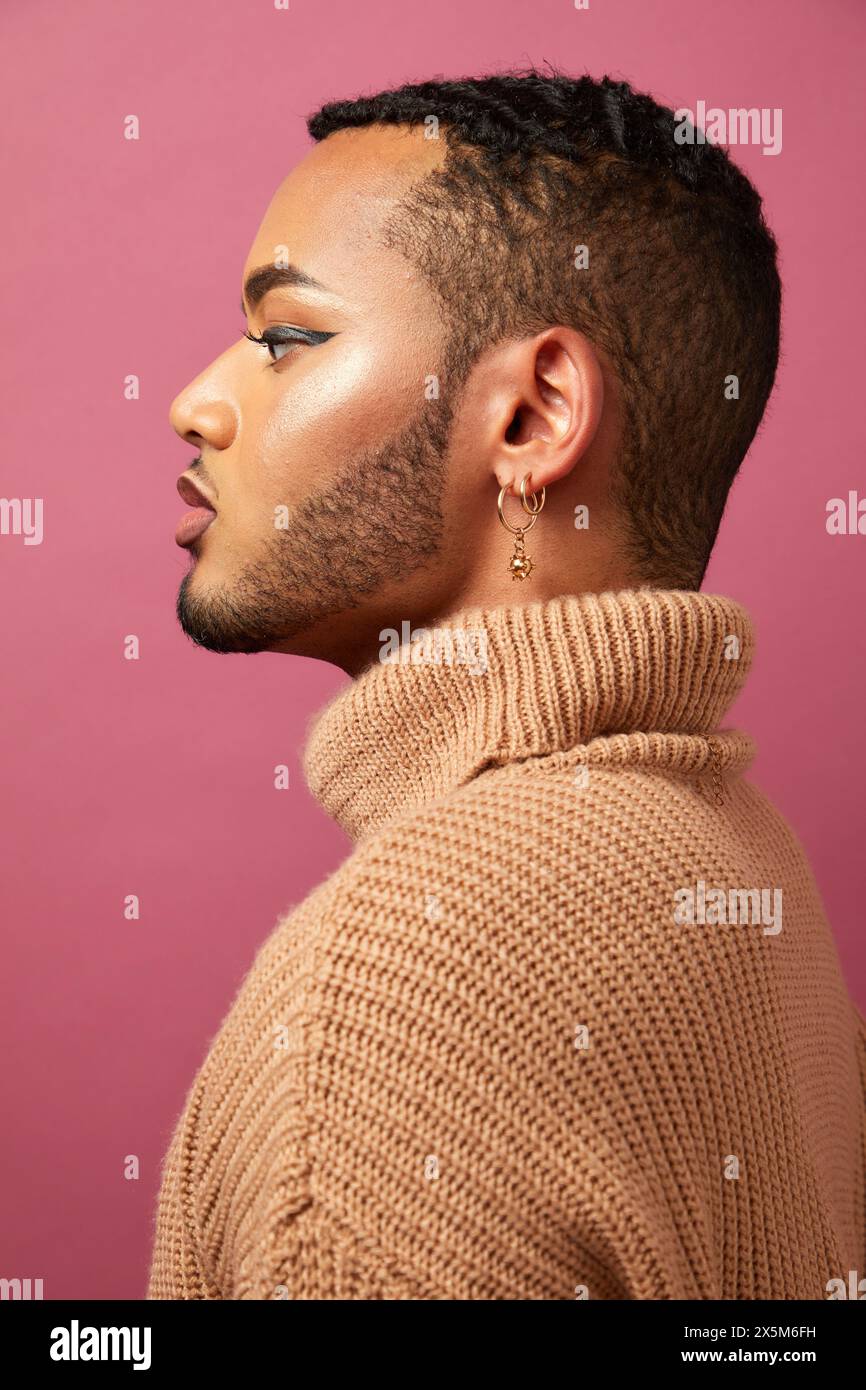 Profile of queer man against purple background Stock Photo - Alamy