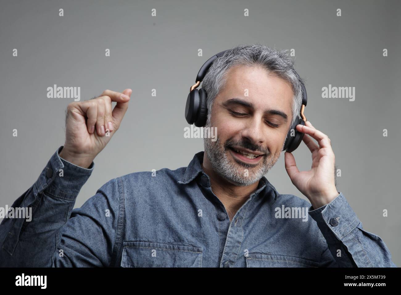 Mature adult listening to music hi-res stock photography and images - Alamy