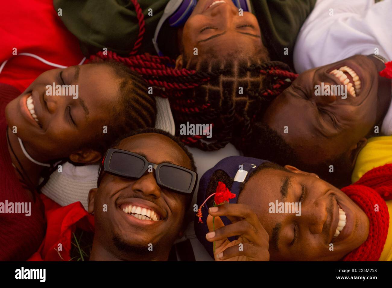 Group of young friends lying on back Stock Photo - Alamy