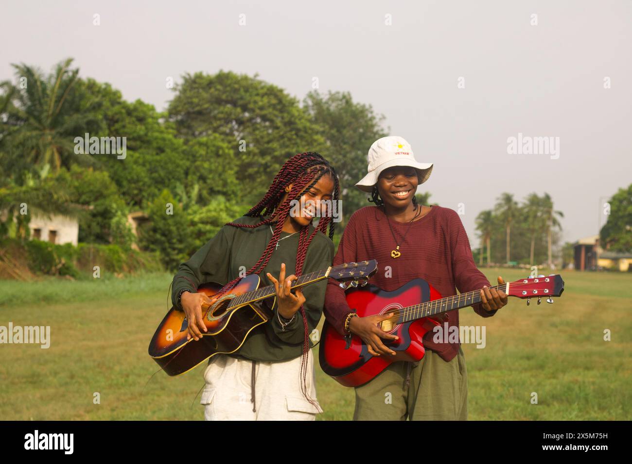 Two young women playing guitars Stock Photo - Alamy