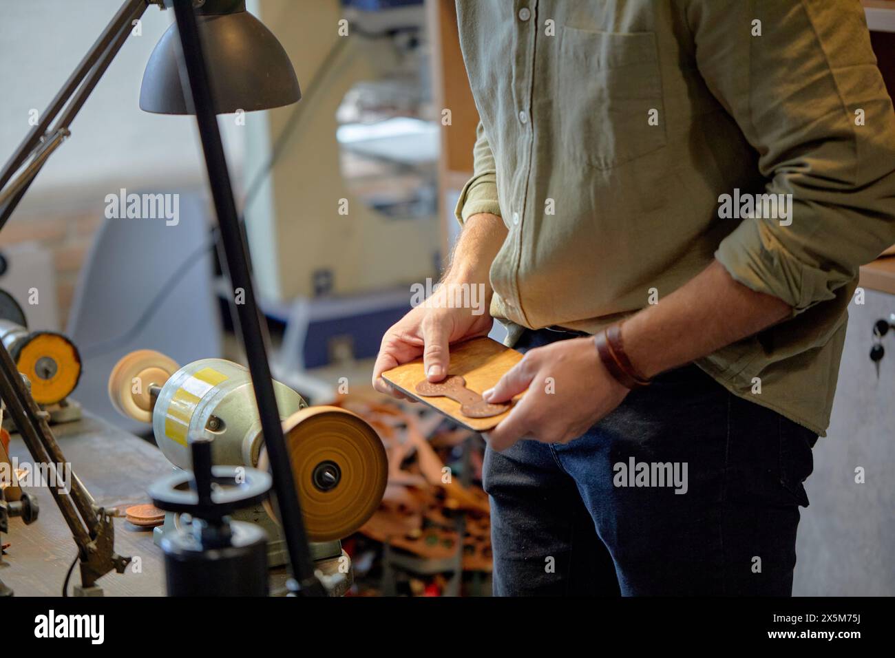male's hands working with Leather Polishing Burnishing Machine Leather ...