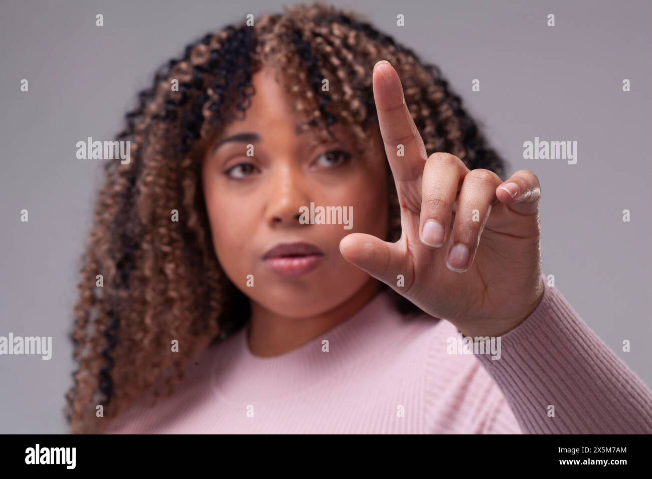 Woman making pointing gesture Stock Photo - Alamy