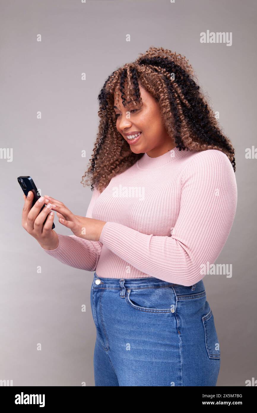 Woman smiling using smart hi-res stock photography and images - Alamy
