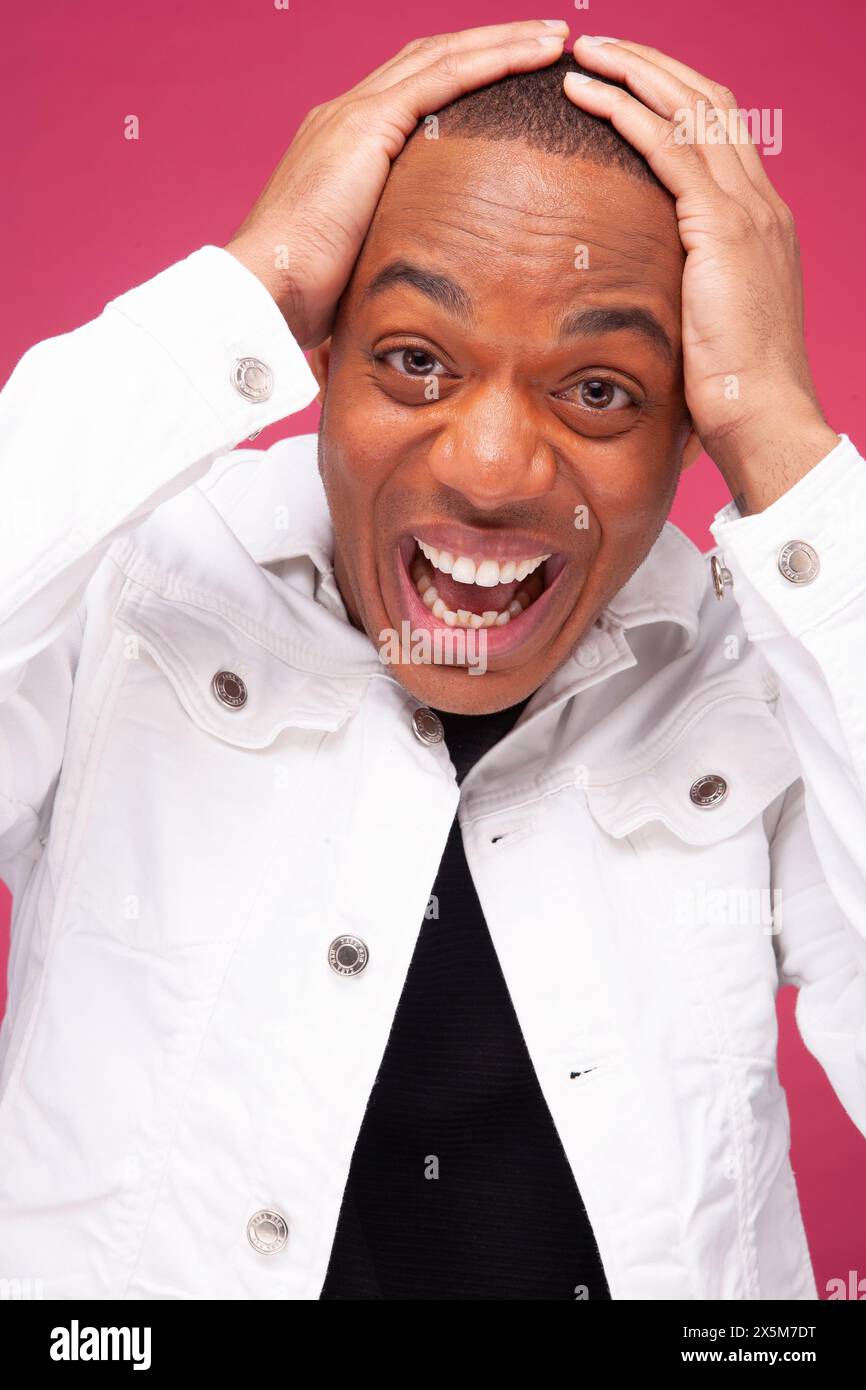 Portrait of laughing man touching head Stock Photo - Alamy