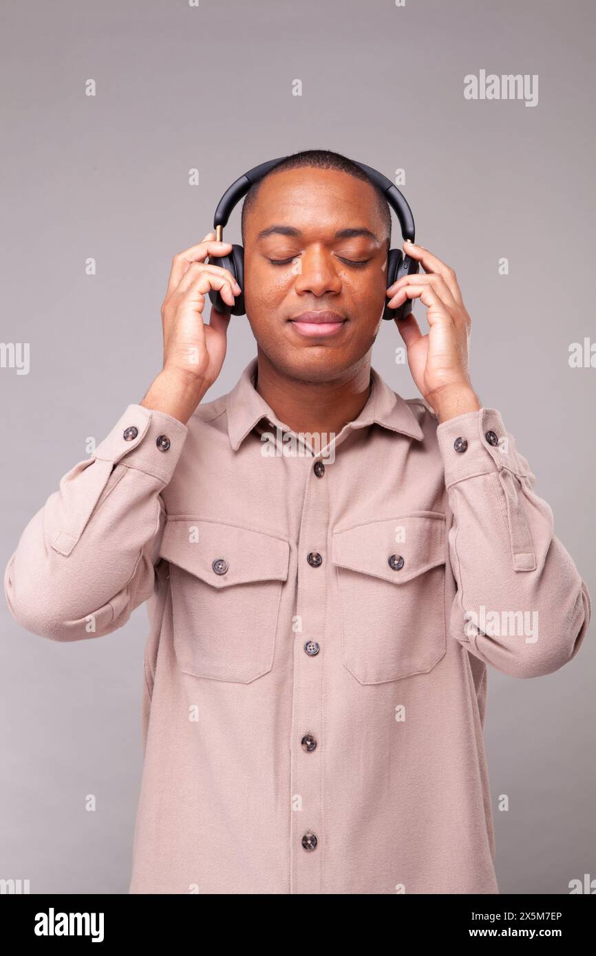 Man in headphones listening to music Stock Photo - Alamy