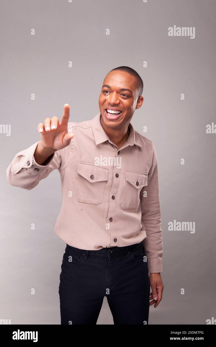 Handsome smiling man pointing hi-res stock photography and images - Alamy