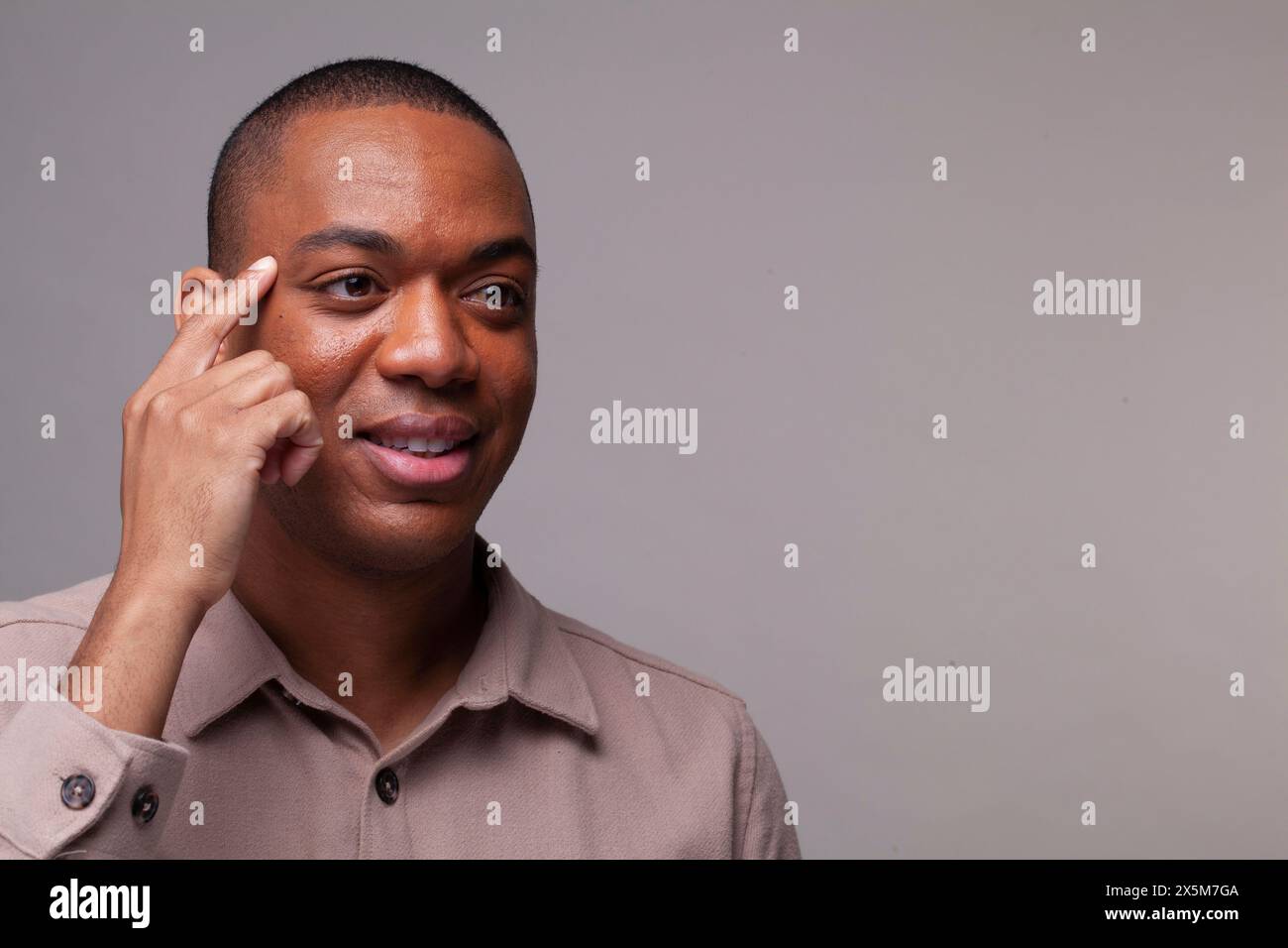 Man making thinking gesture Stock Photo - Alamy