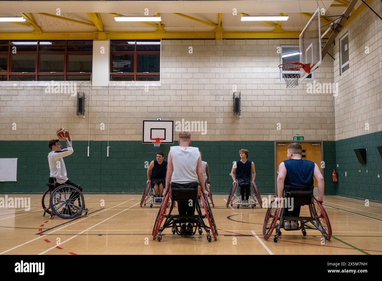 Man in wheelchair doing free throw during match Stock Photo - Alamy