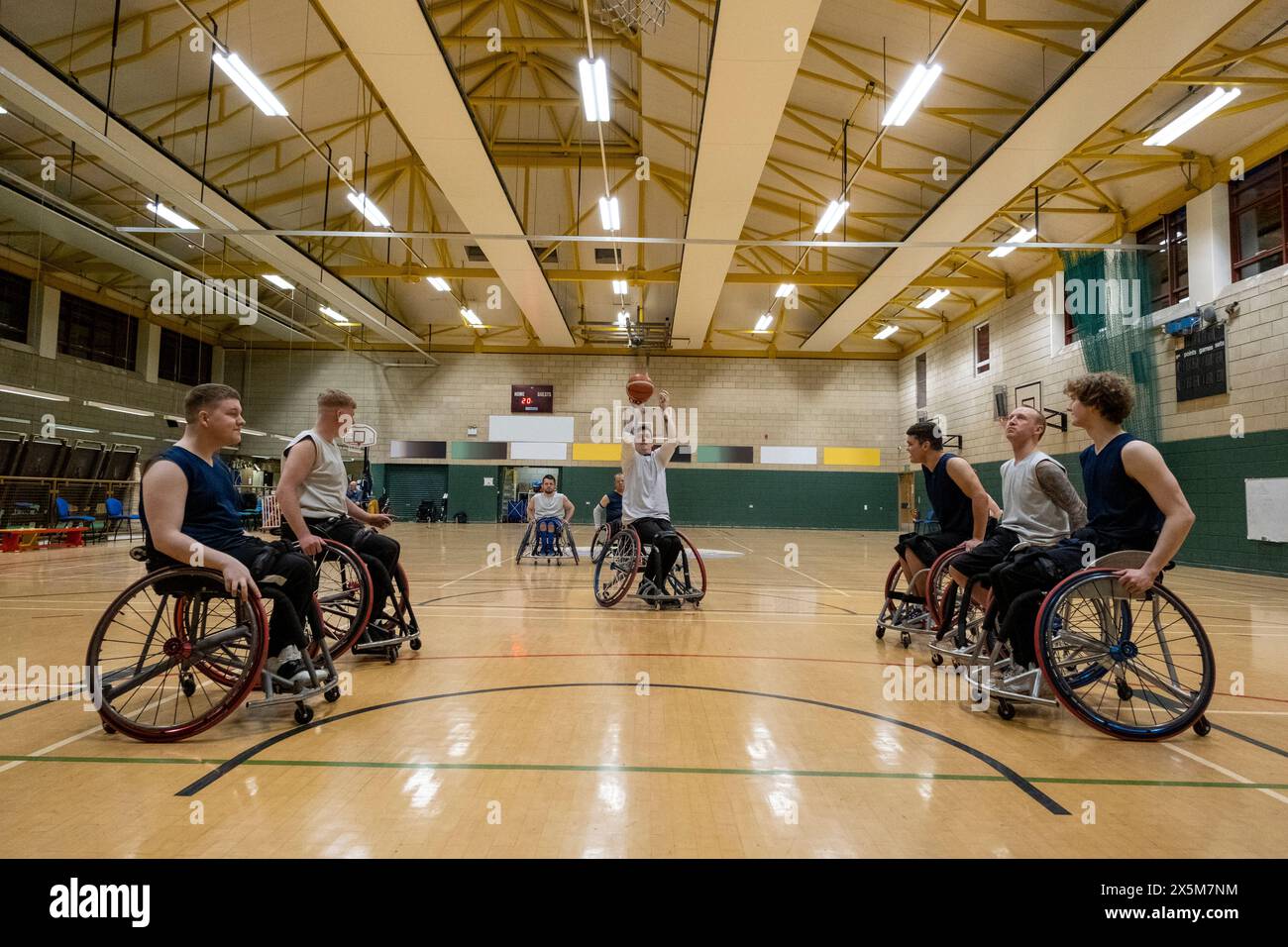Man in wheelchair doing free throw during match Stock Photo - Alamy