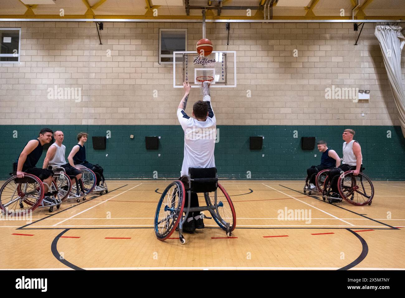 Man in wheelchair doing free throw during match Stock Photo - Alamy