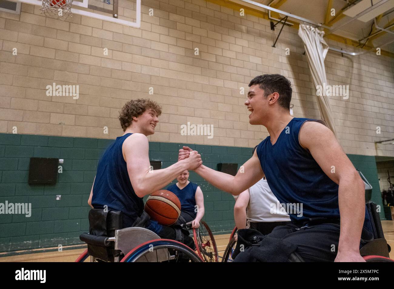 Men in wheelchairs shaking hands after match Stock Photo - Alamy